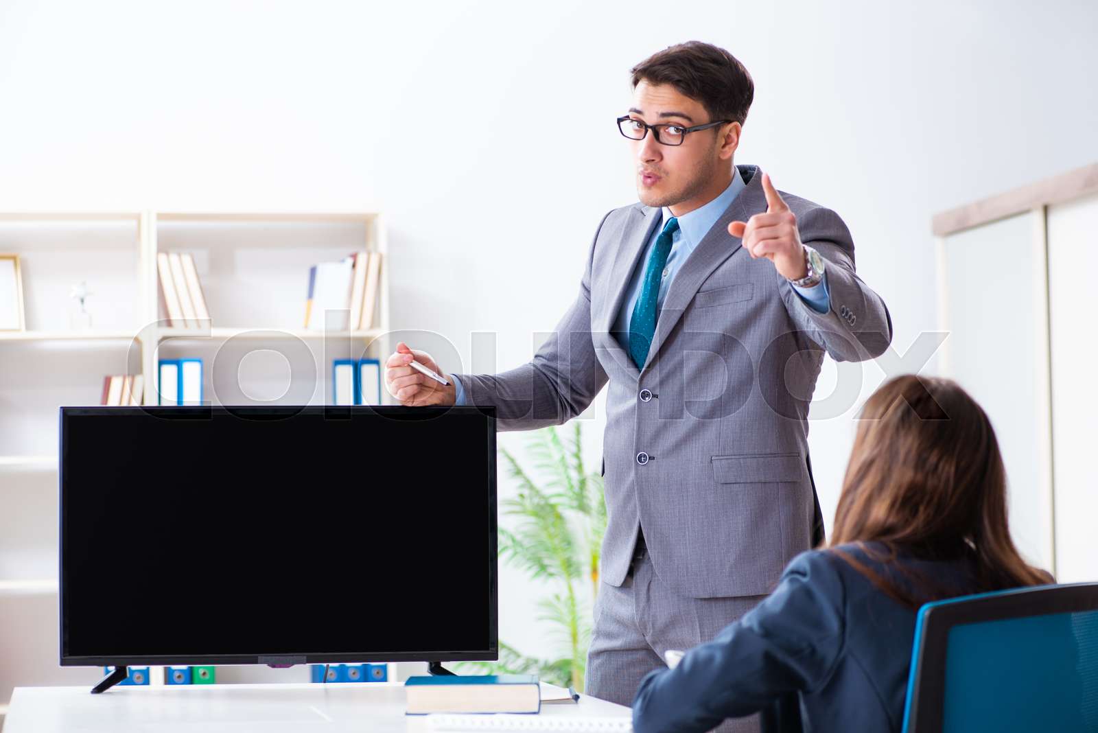 Young Employee Making Presentation To His Female Boss Stock Image