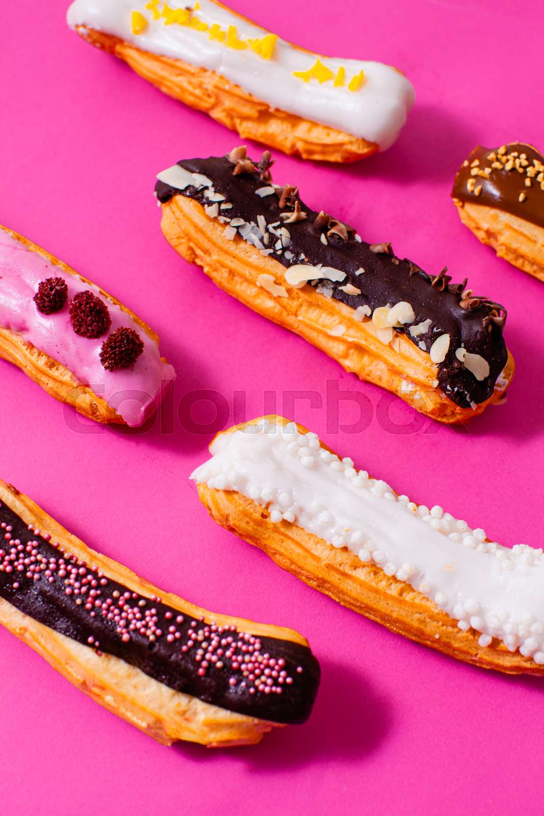 Several eclairs with different colored types of fillings | Stock image ...