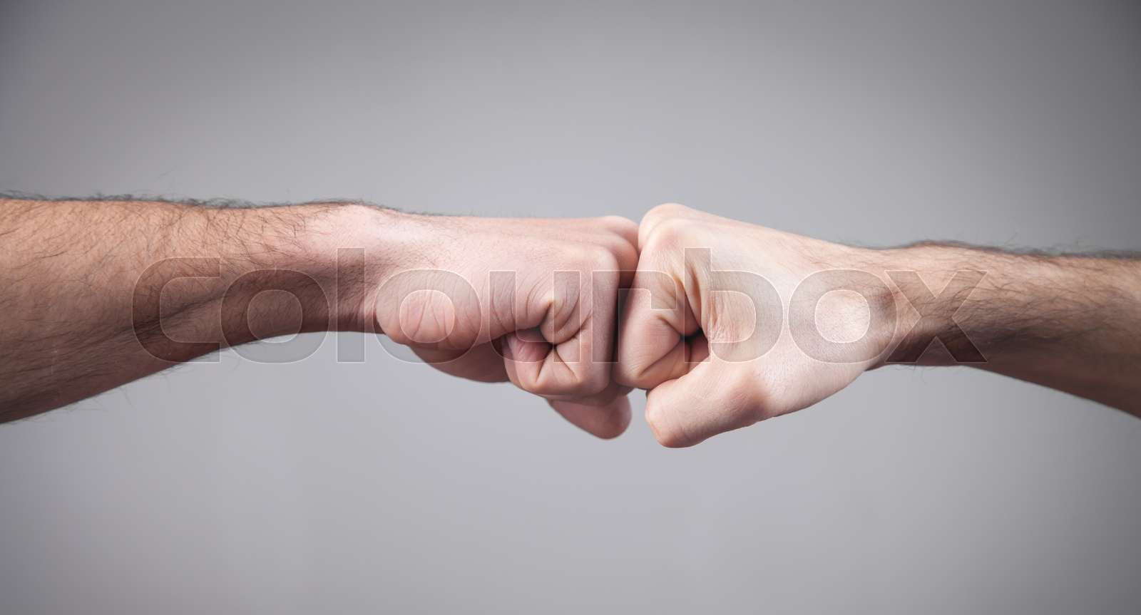 Close-up. Two fists hitting each other. Fight | Stock image | Colourbox