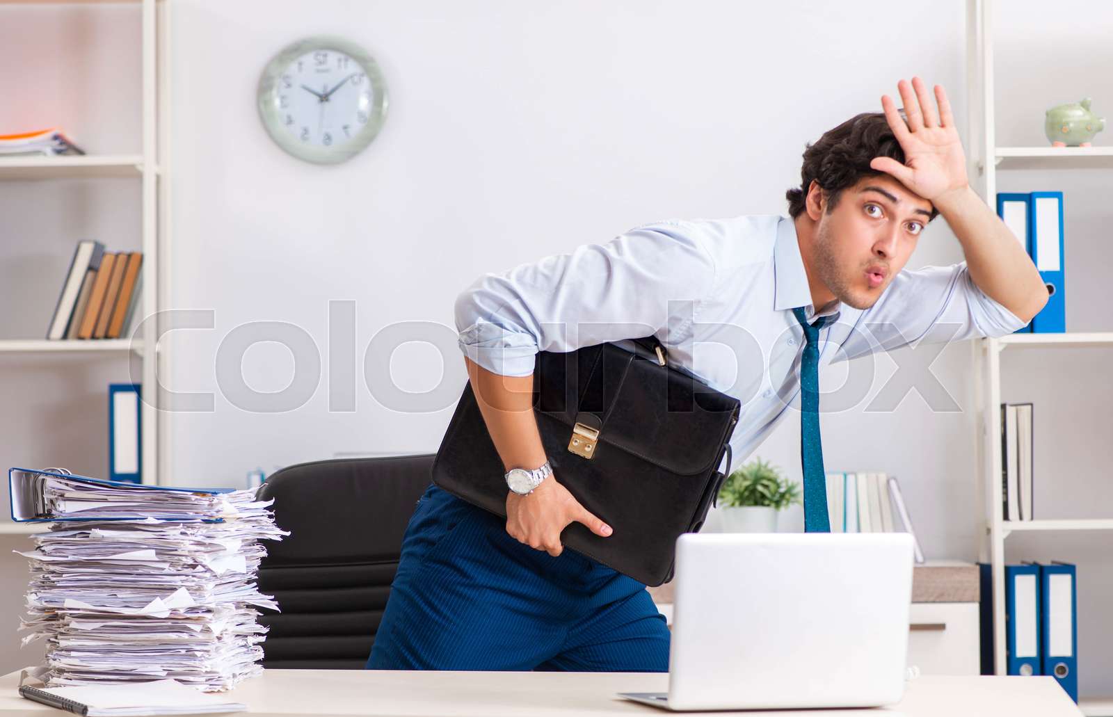 Overloaded busy employee with too much work and paperwork | Stock image ...