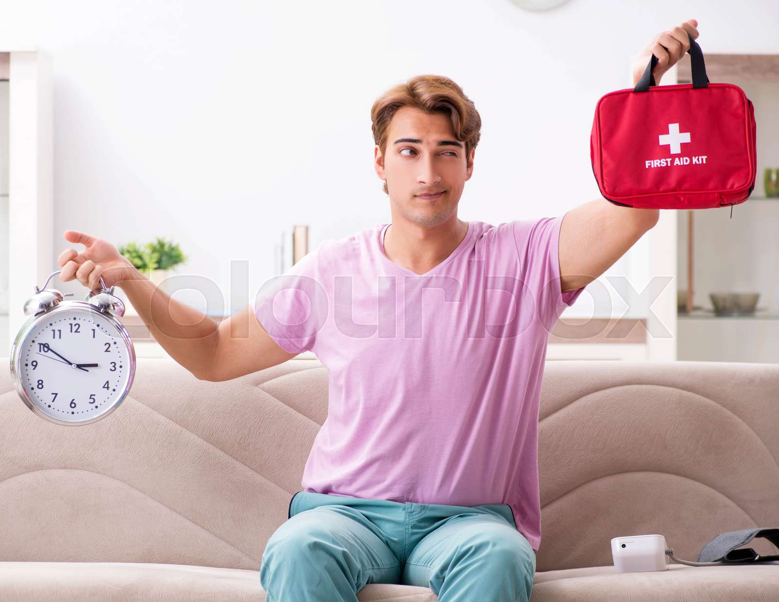 Sick man at home with first aid kit | Stock image | Colourbox