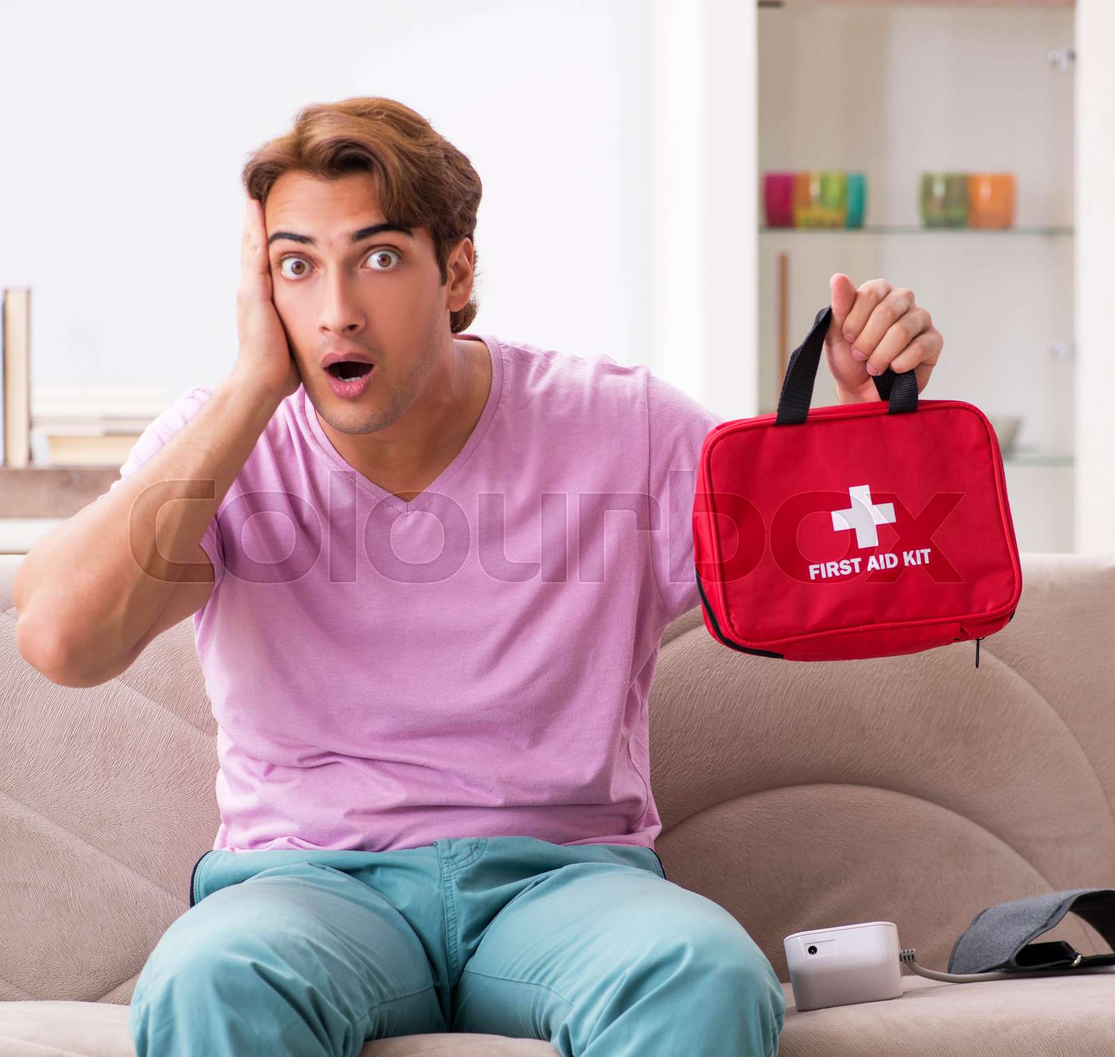 Sick man at home with first aid kit | Stock image | Colourbox