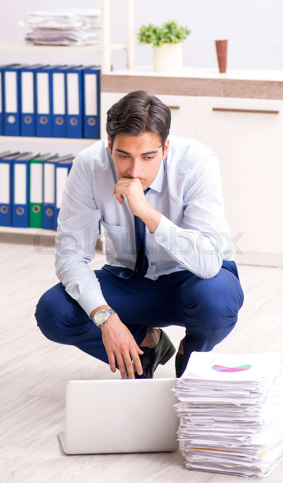 Extremely busy employee working in the office | Stock image | Colourbox