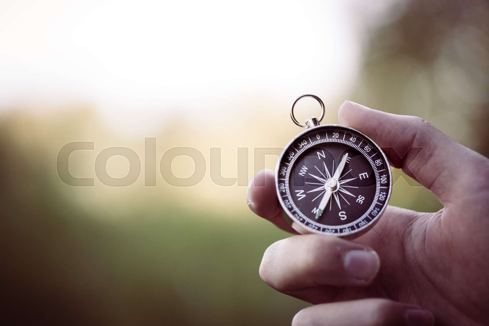 Compass holding in the hand, outdoor adventure | Stock image | Colourbox