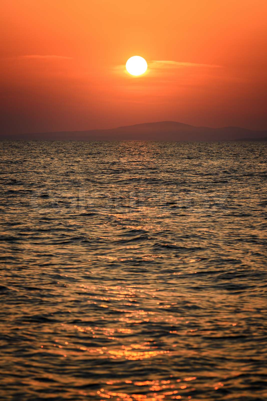 Bright sunset with yellow sun the sea surface | Stock image | Colourbox