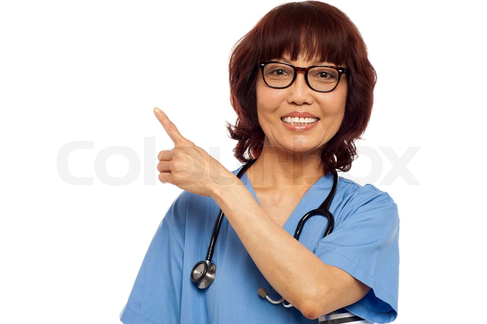Nurse pointing at the copy space | Stock image | Colourbox