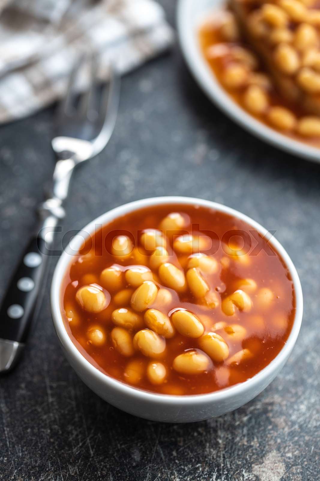 Baked beans in bowl. Beans with tomato sauce | Stock image | Colourbox