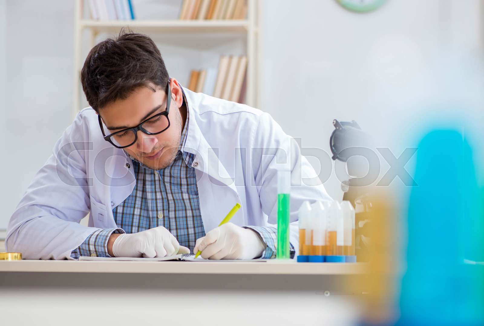 Young chemist student working in lab on chemicals | Stock image | Colourbox