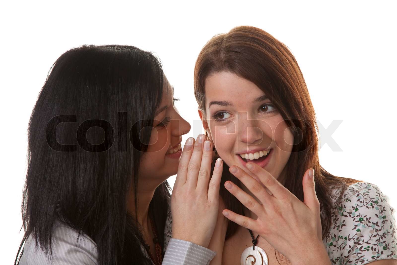 two young women whisper to each other | Stock image | Colourbox