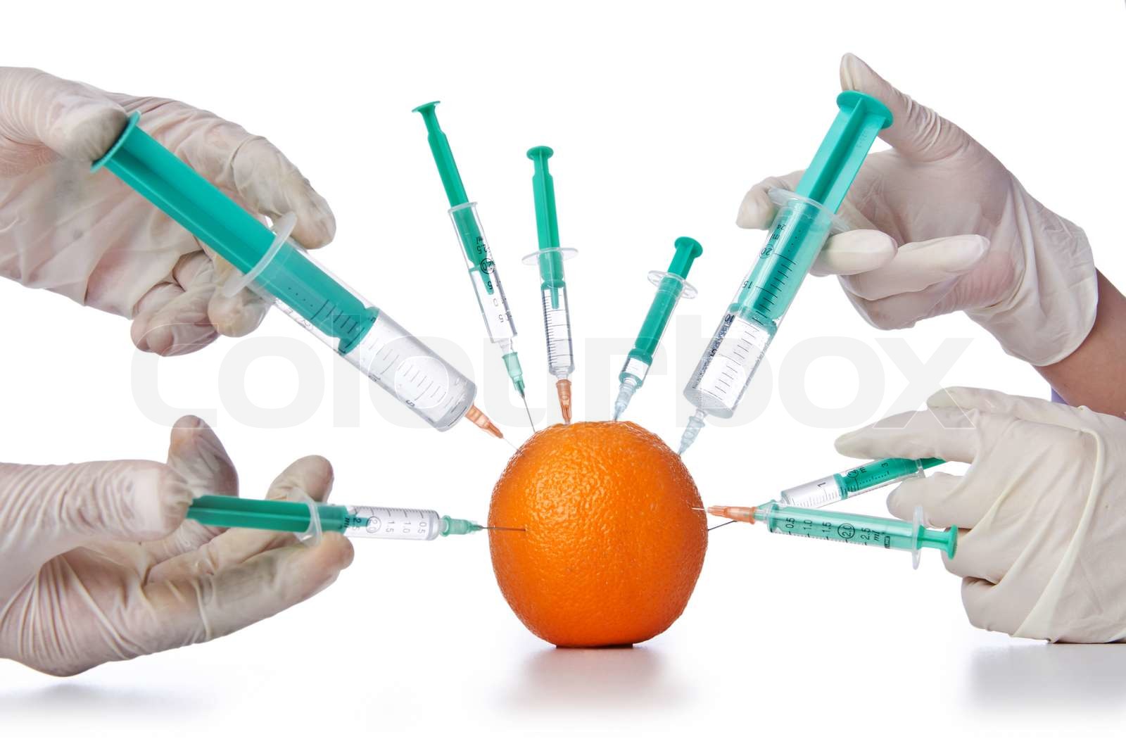 Science experiment with orange and syringe | Stock image | Colourbox