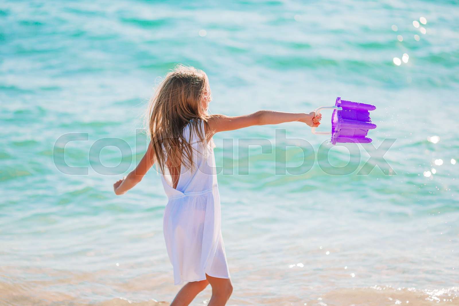 Adorable active little girl at beach during summer vacation | Stock ...