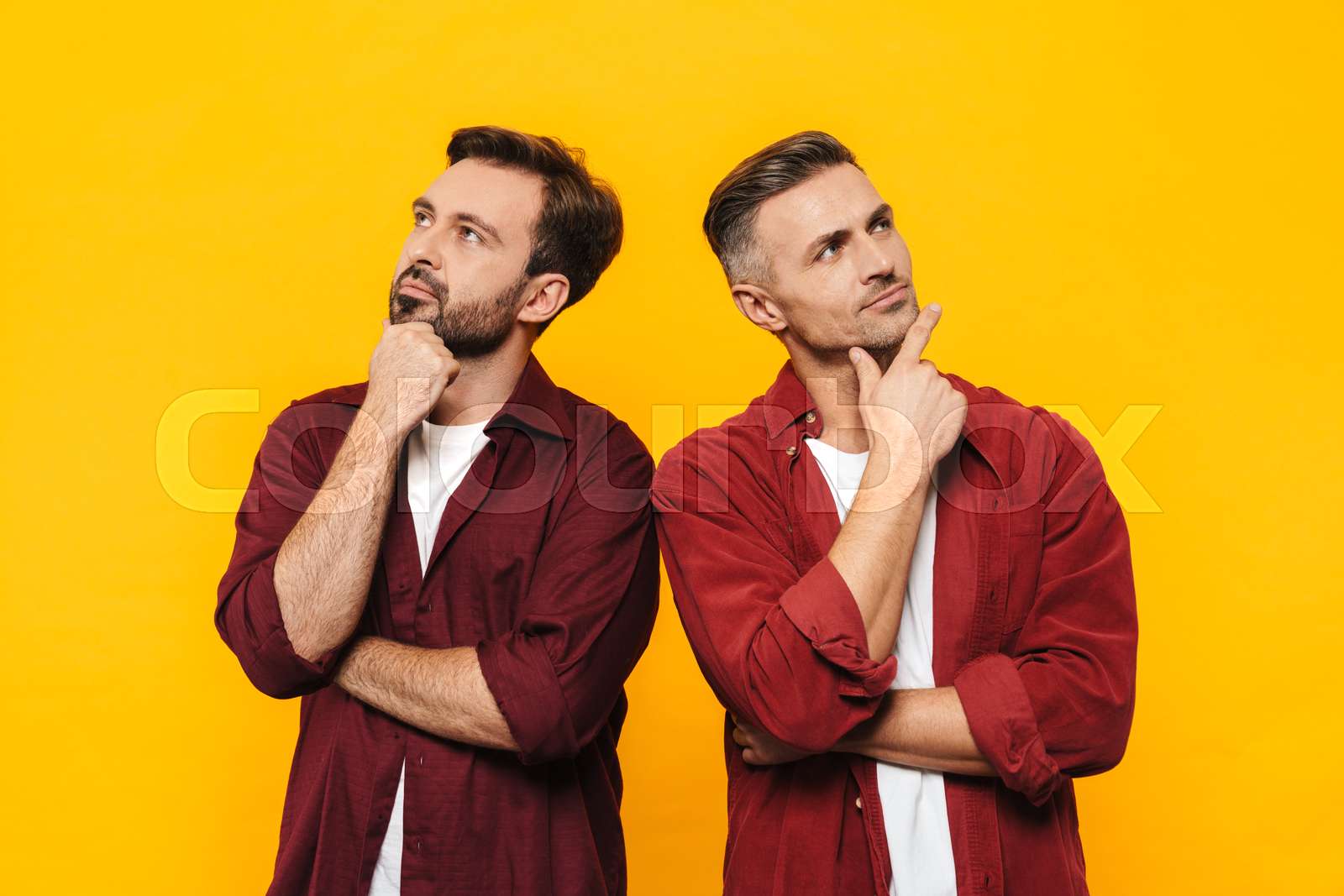 Image of two handsome men thinking and looking upwards at copyspace ...