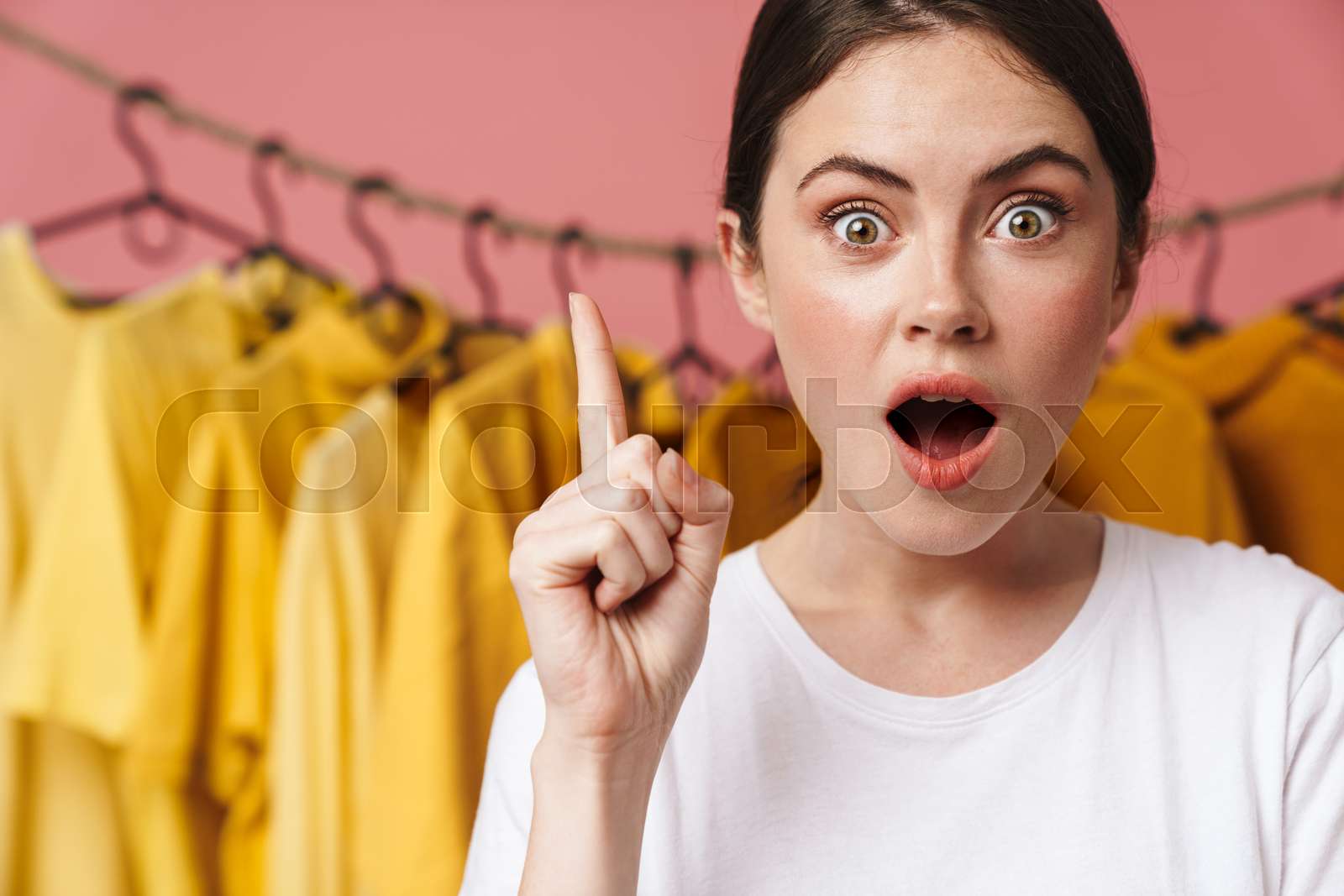 Photo of surprised woman expressing shock and pointing finger upward ...