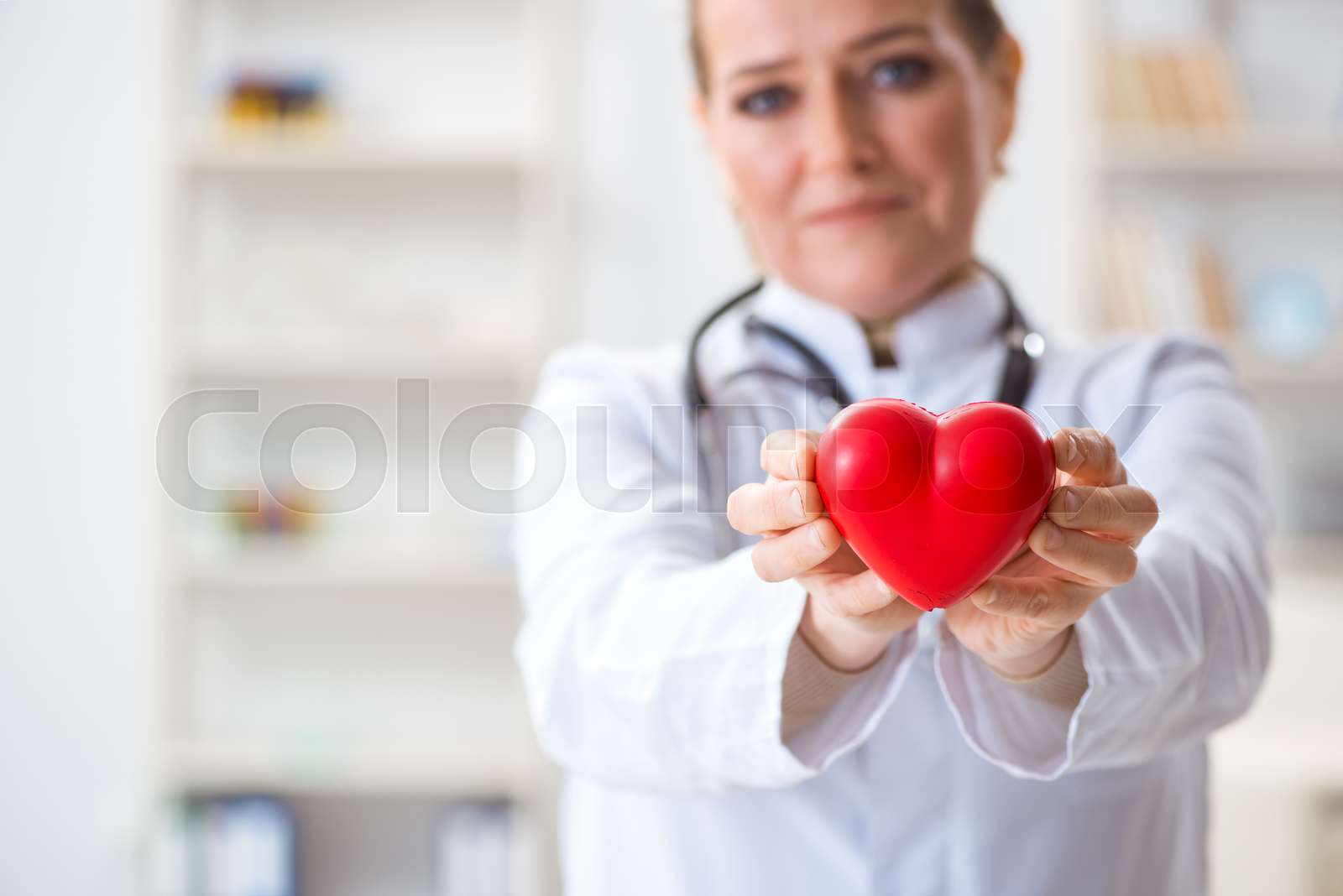Cardiologist with red heart in medical concept | Stock image | Colourbox
