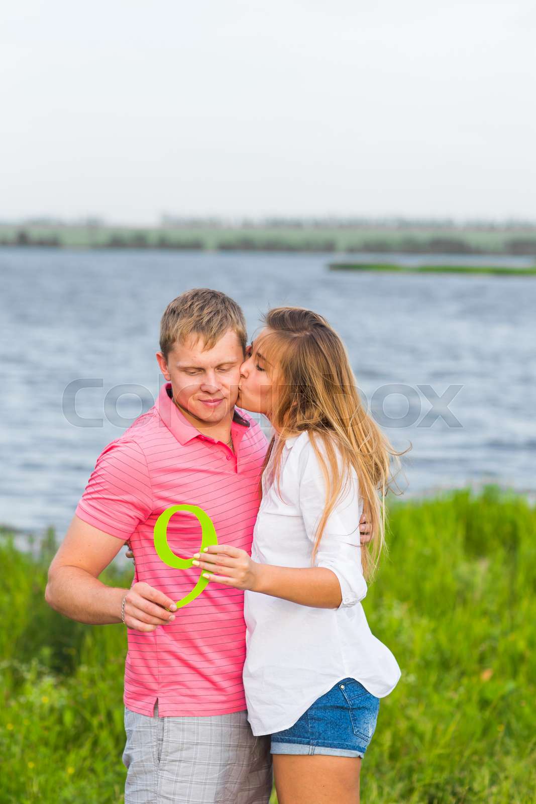 Man And Woman Holding The Number 9 In Nature Concept Of Numbers
