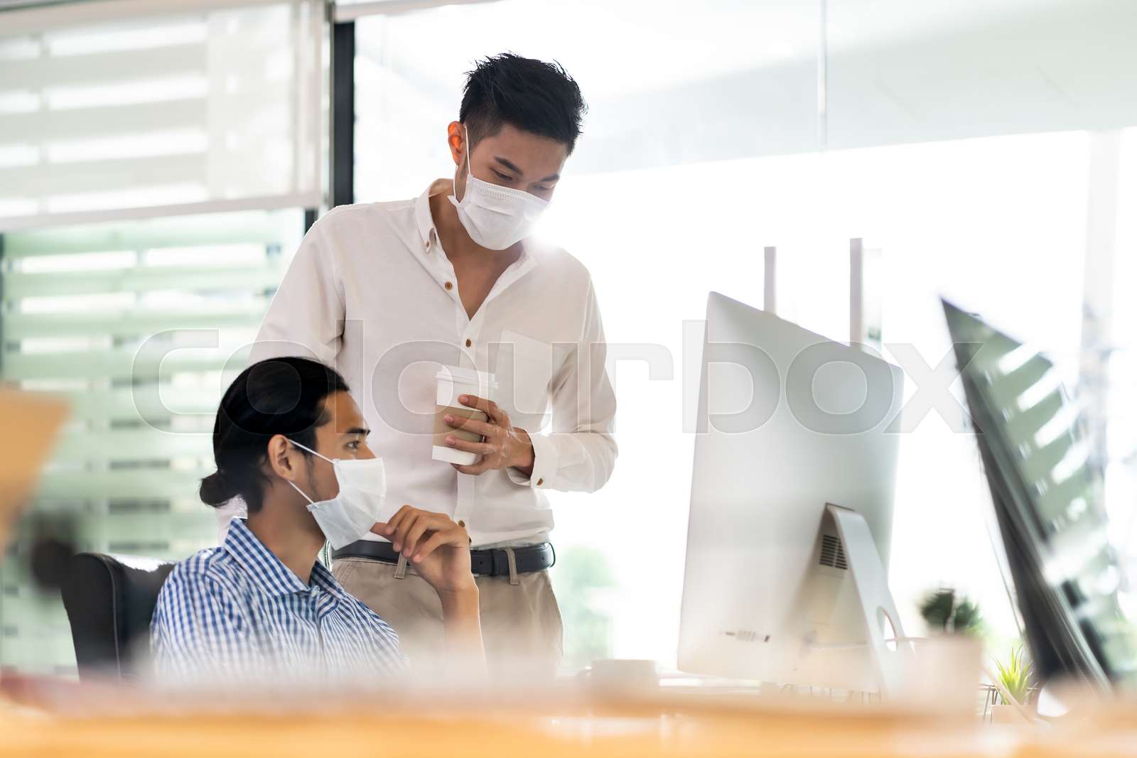 Businessmen wear face mask dicuss in new normal office | Stock image | Colourbox