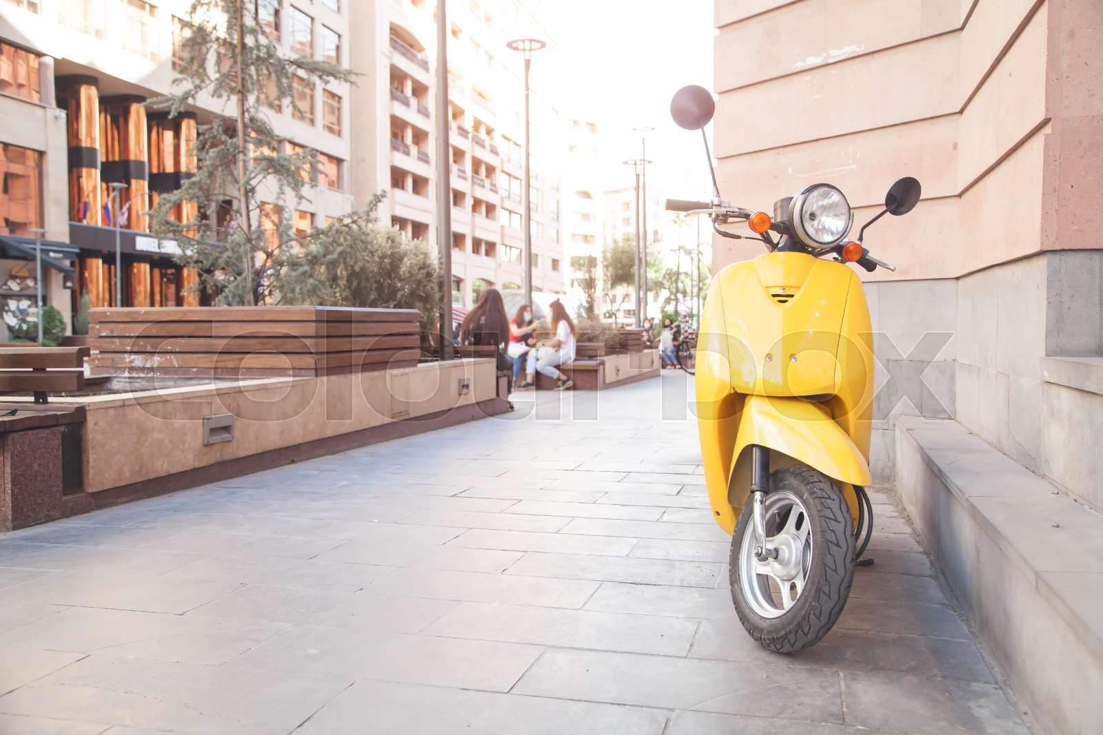 Yellow modern moped in a city. | Stock image | Colourbox