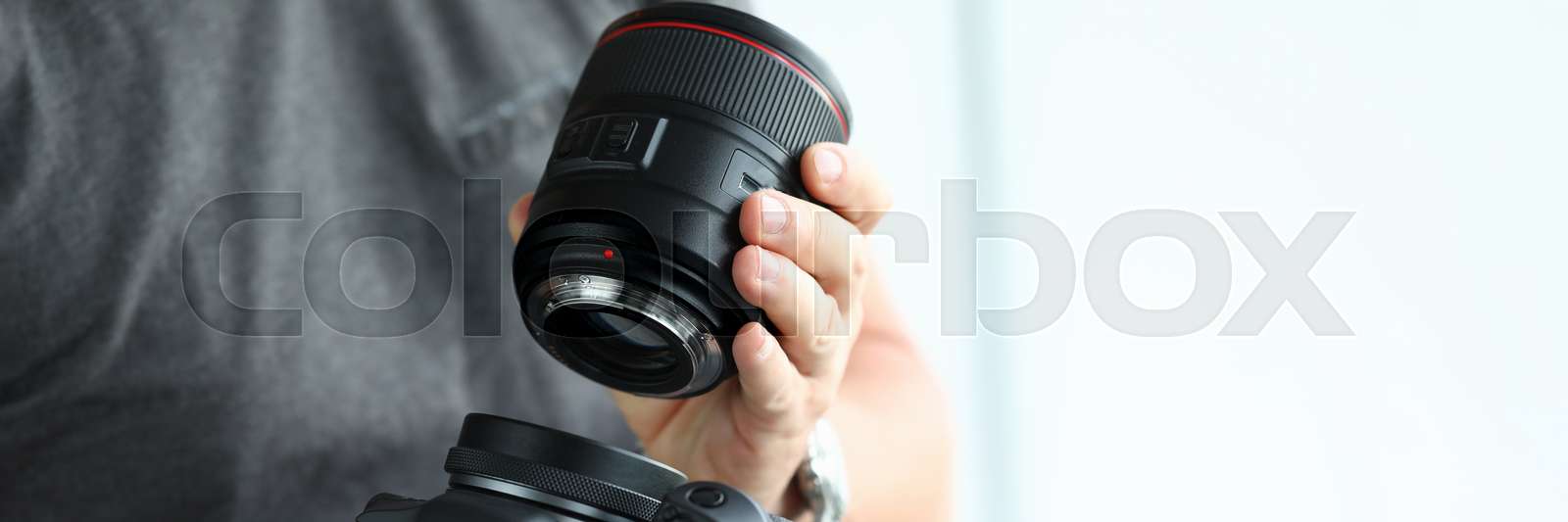 Male hands putting on modern digital camera professional lens | Stock ...