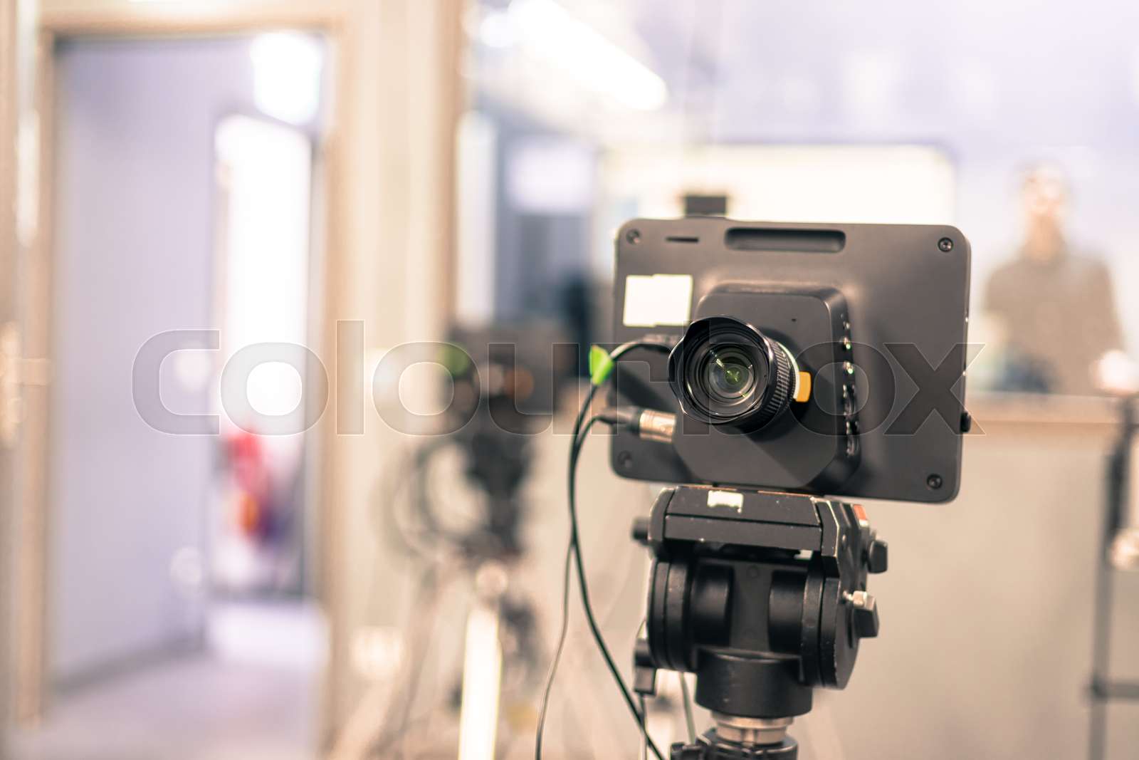Film camera in broadcasting studio, spotlights and other equipment ...