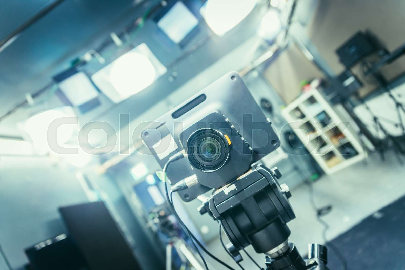 Film camera in broadcasting studio, spotlights and other equipment ...