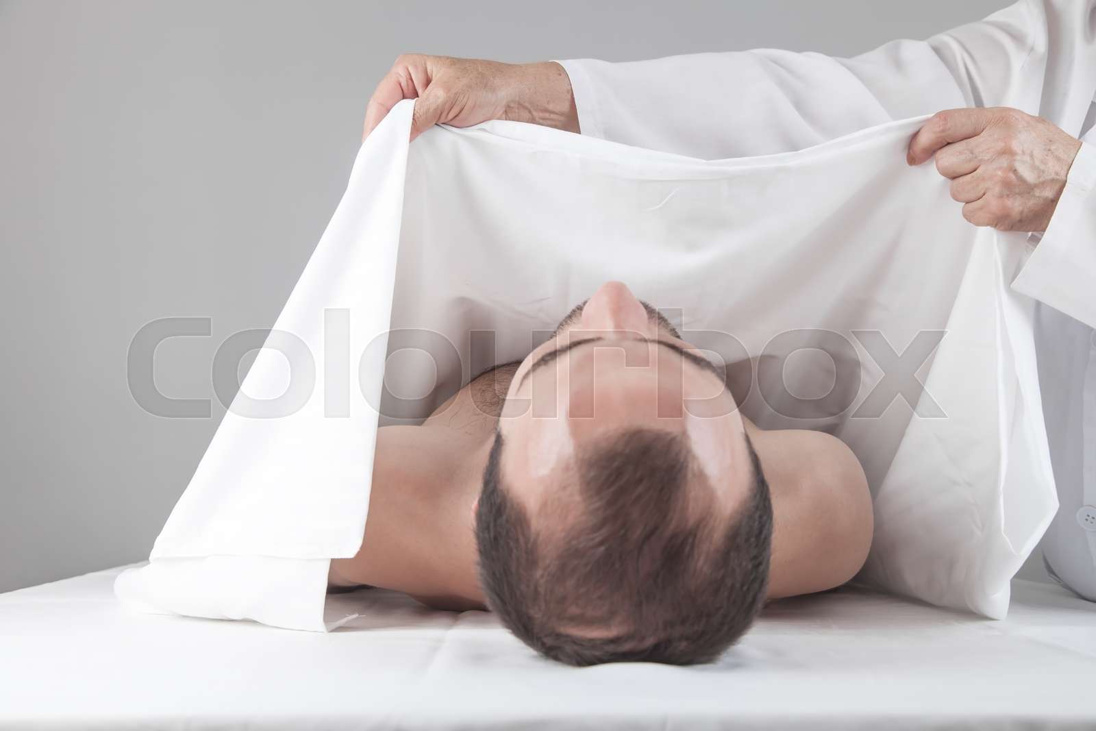 A dead man is lying in the morgue. | Stock image | Colourbox