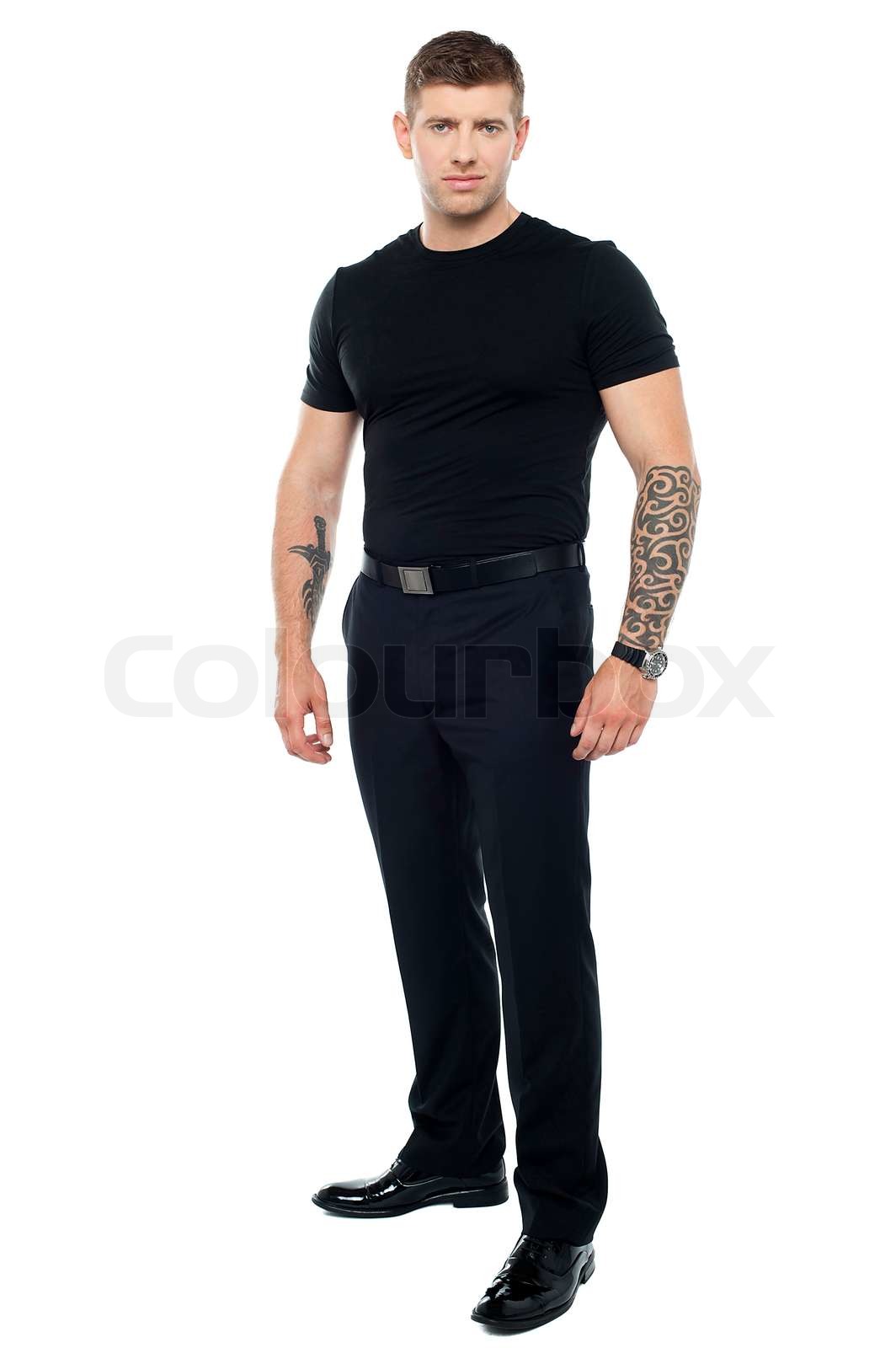 Strong male bouncer. Tattoo on both his hands | Stock image | Colourbox