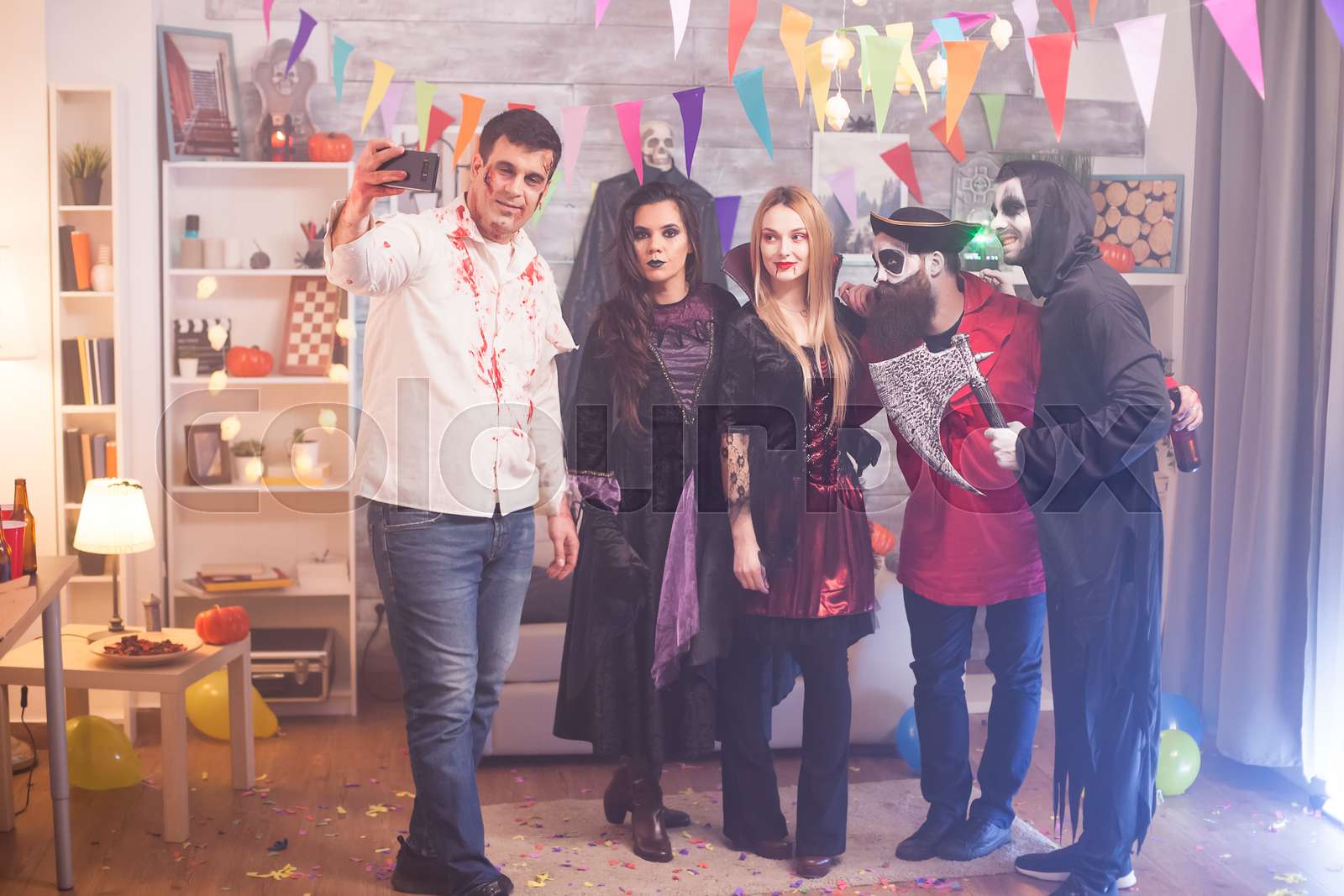 Bloody zombie taking a selfie with his friends | Stock image | Colourbox