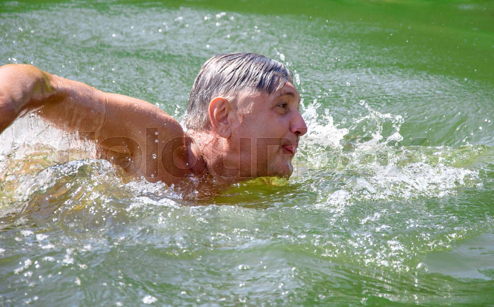 Man swimming in open water. Healthy lifestyle. | Stock image | Colourbox