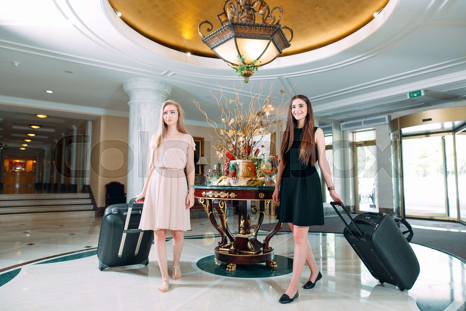 Young girls near reception desk in hotel. Young girls comes to the ...