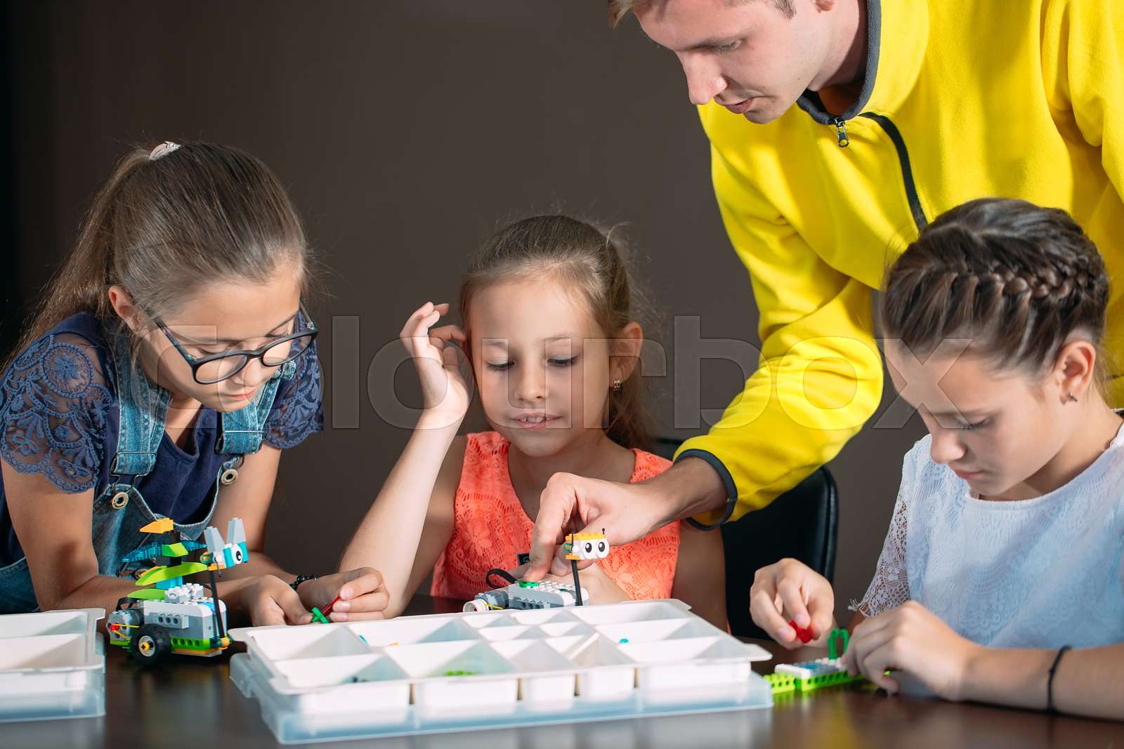 Kids creating robots with teacher. Early development, diy, innovation ...