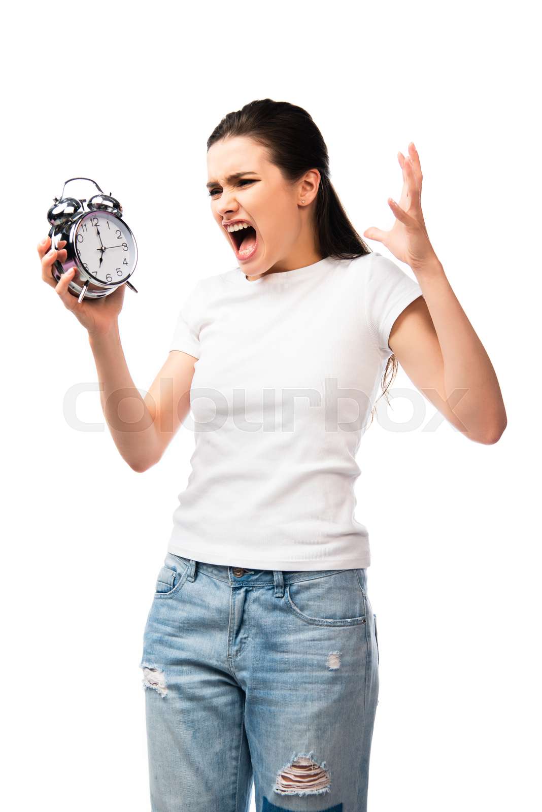 angry woman in white t-shirt holding retro alarm clock while screaming ...