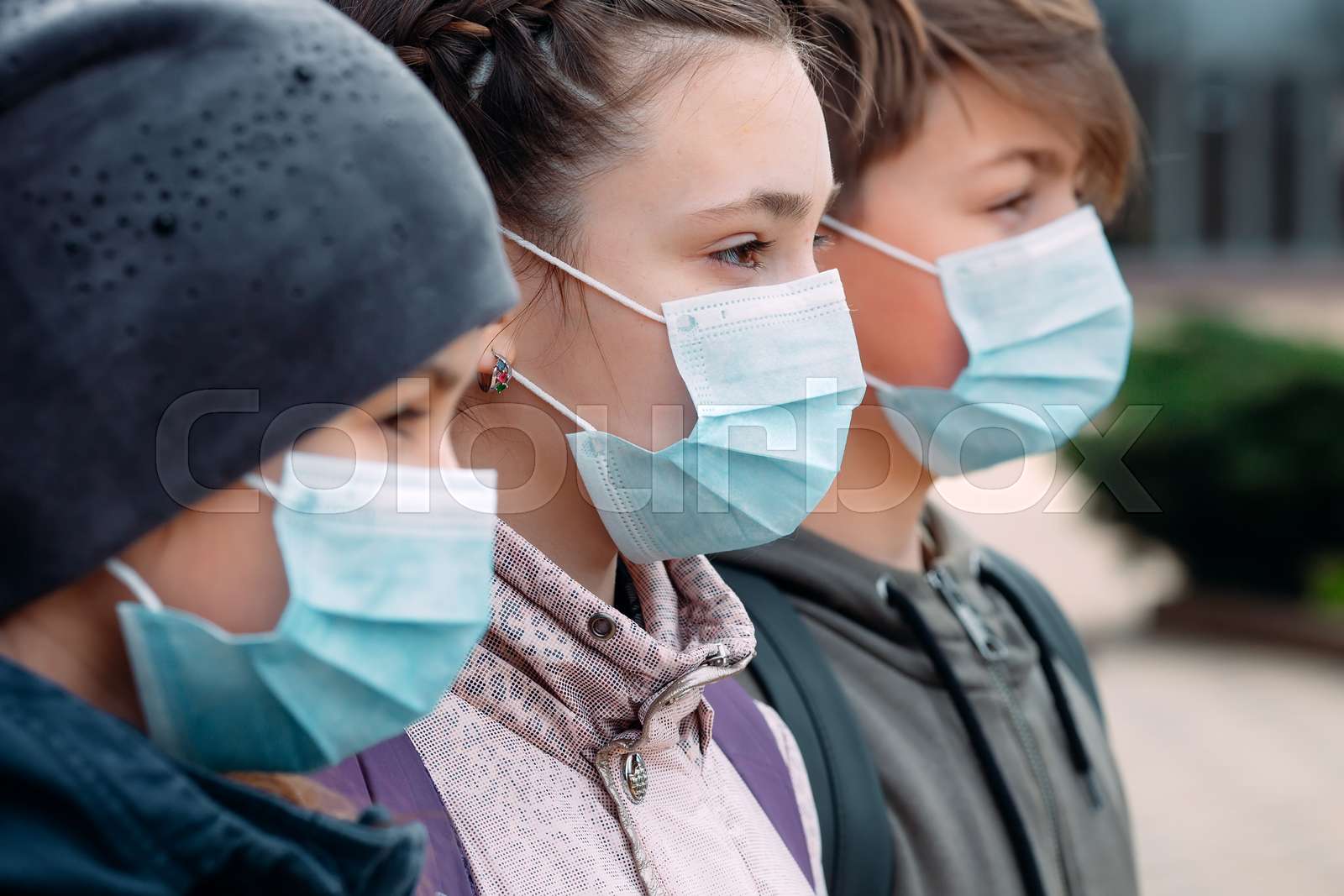 School-age children in medical masks. portrait of school children ...
