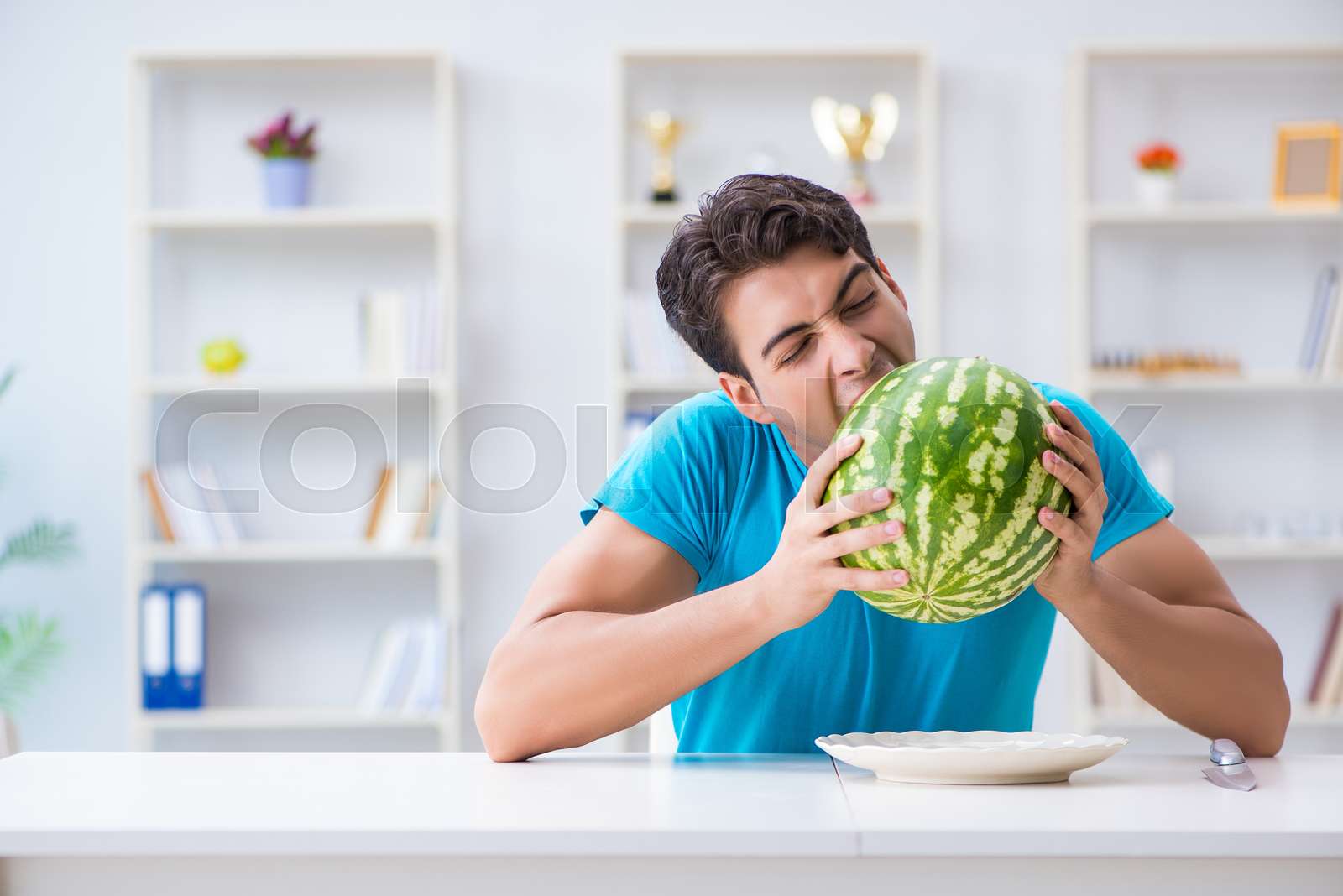 Man eating watermelon at home | Stock image | Colourbox
