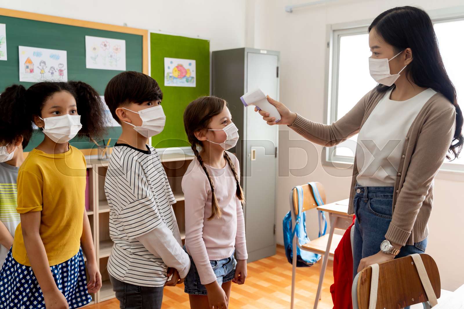 Group of diverse students in school building checked and scanned for ...