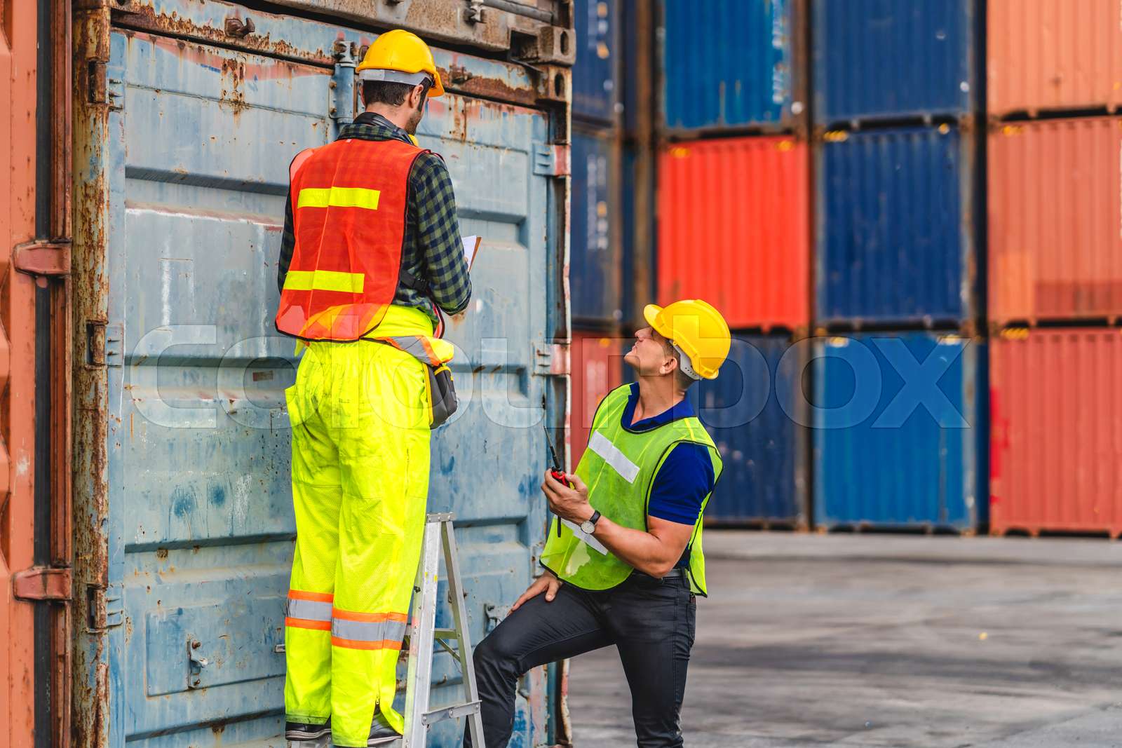 Professional of two engineer container cargo foreman in helmets working ...