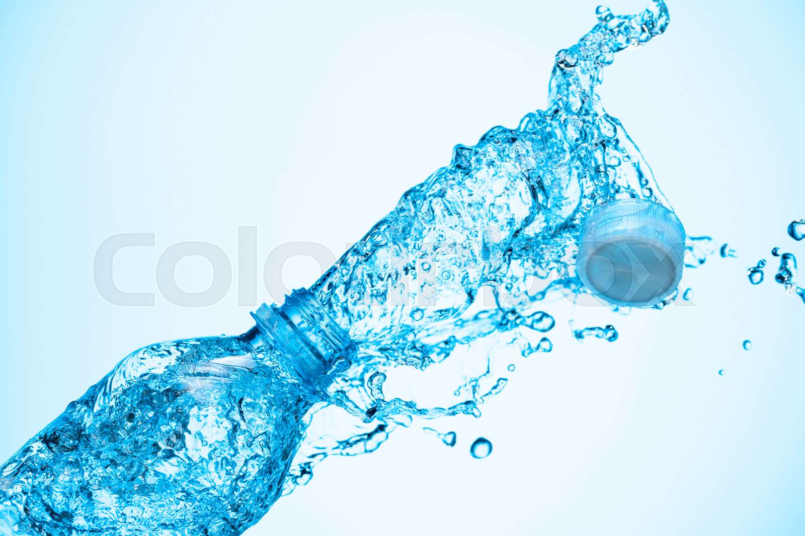 Water is poured out of a plastic bottle. | Stock image | Colourbox