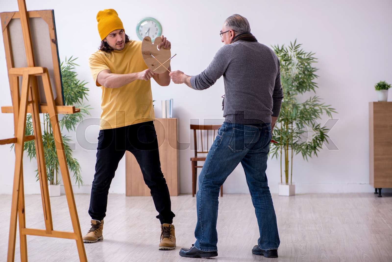 Old man taking lesson from young painter | Stock image | Colourbox