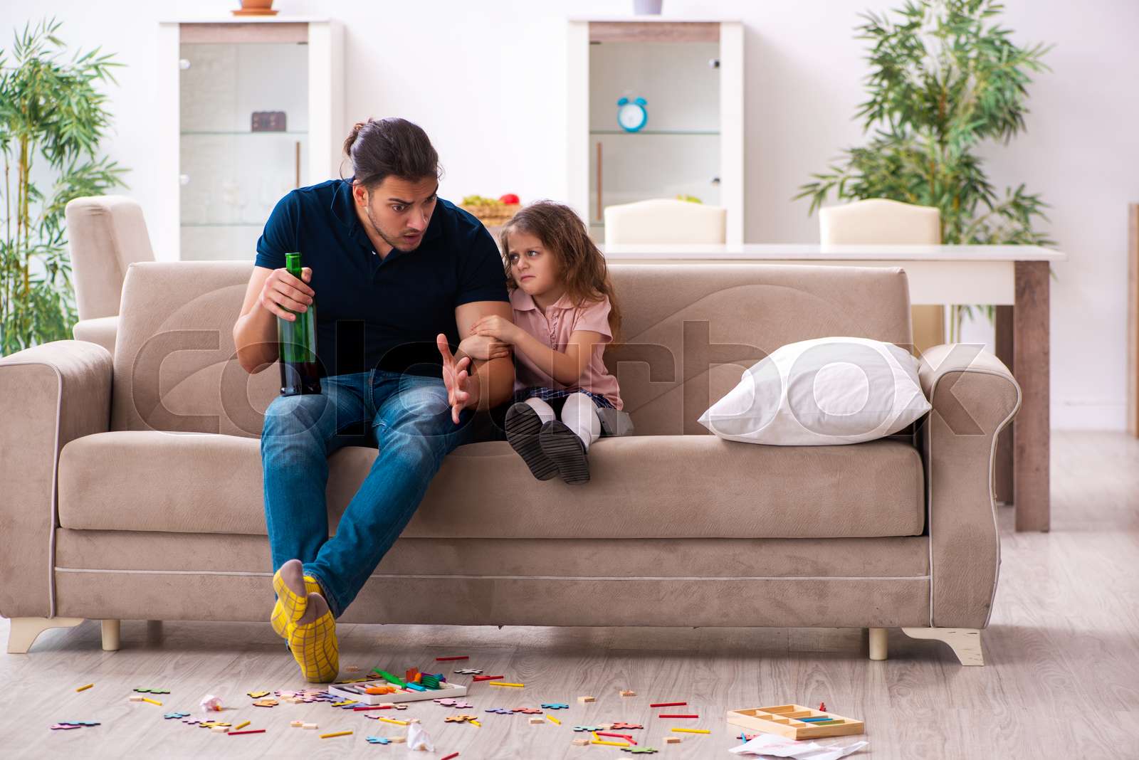 Drunk father and little girl indoors | Stock image | Colourbox