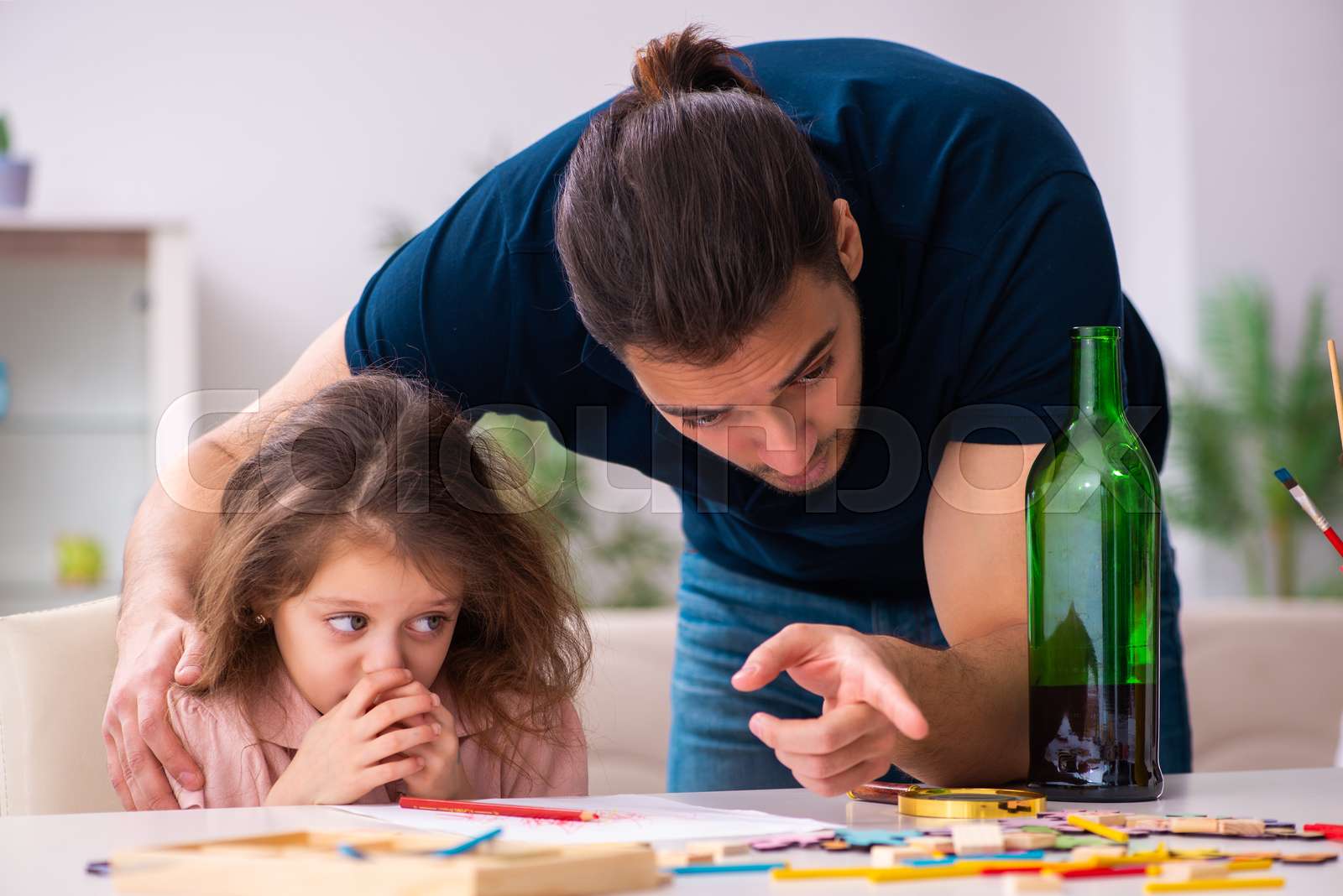 Drunk father and little girl indoors | Stock image | Colourbox