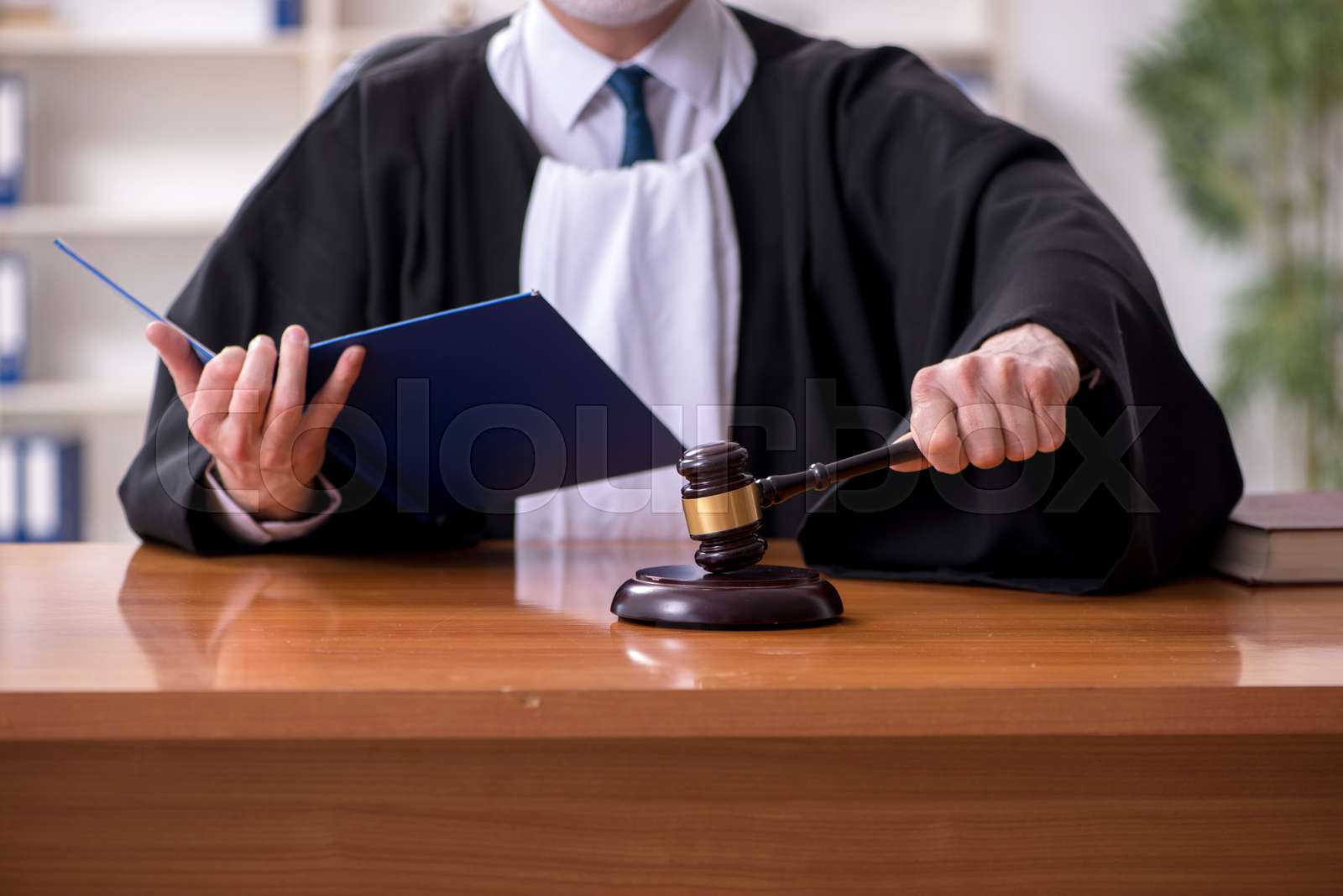 Old male judge working in courthouse | Stock image | Colourbox
