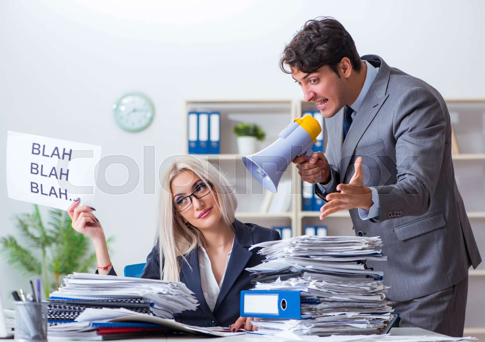Angry boss yelling at his assistant secretary | Stock image | Colourbox