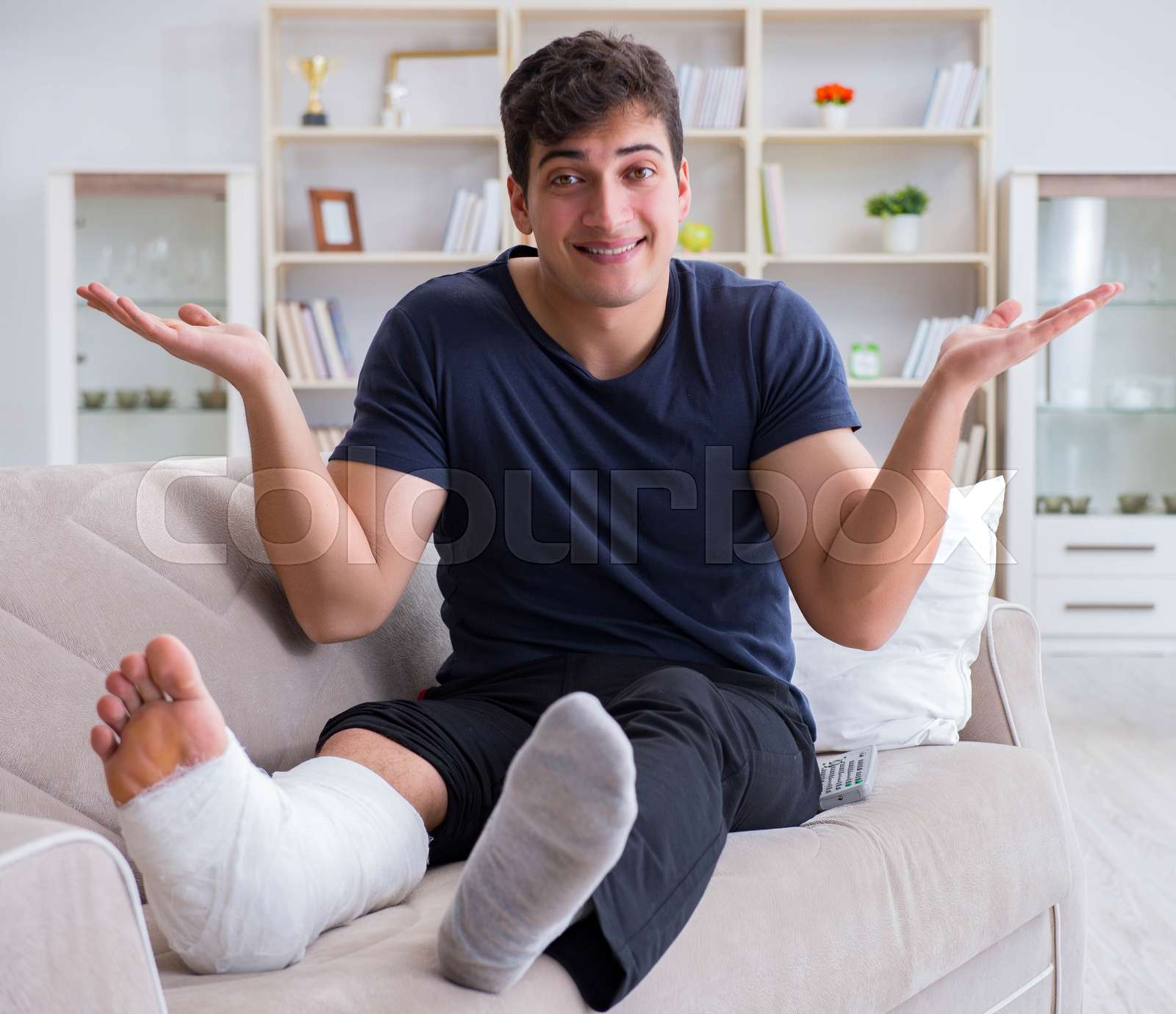 Man with broken leg recovering at home | Stock image | Colourbox