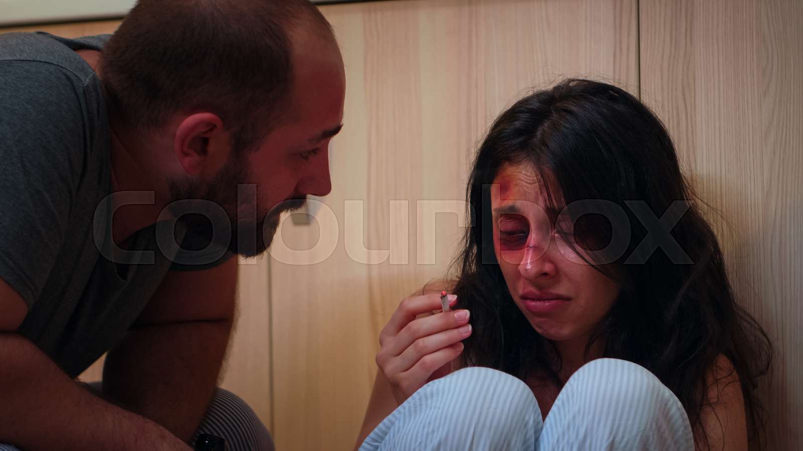 Traumatised wife smoking and crying | Stock image | Colourbox