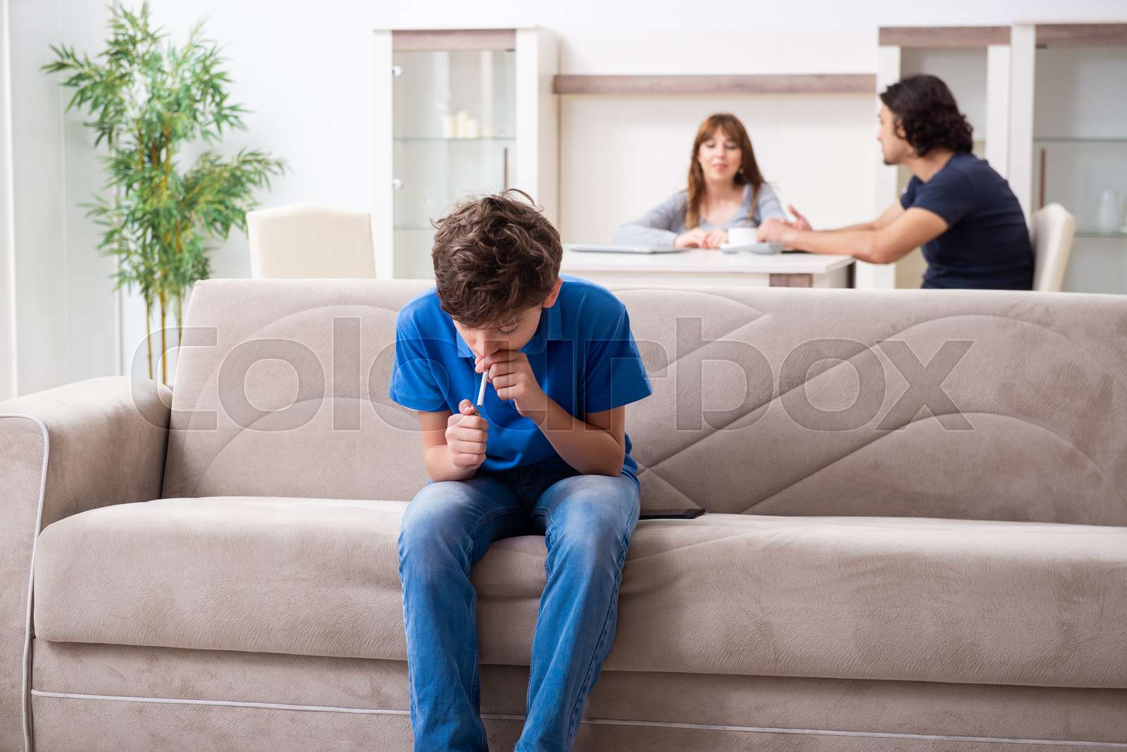 Concept of underage smoking with young boy and family | Stock image ...
