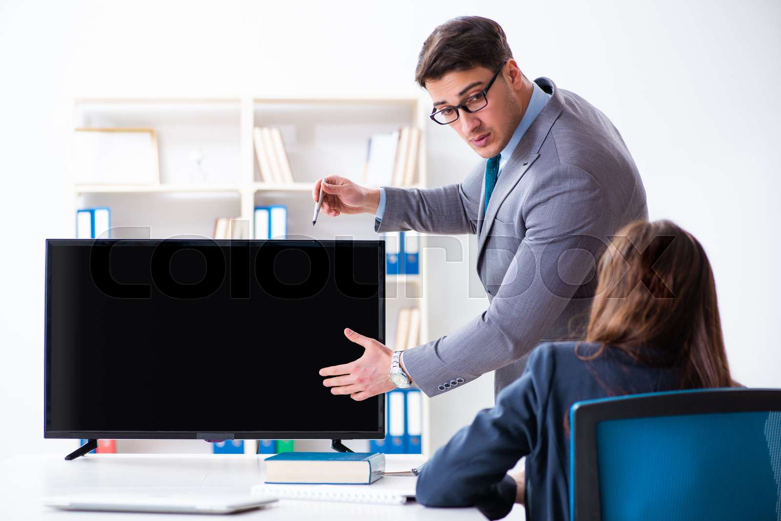 Young Employee Making Presentation To His Female Boss Stock Image
