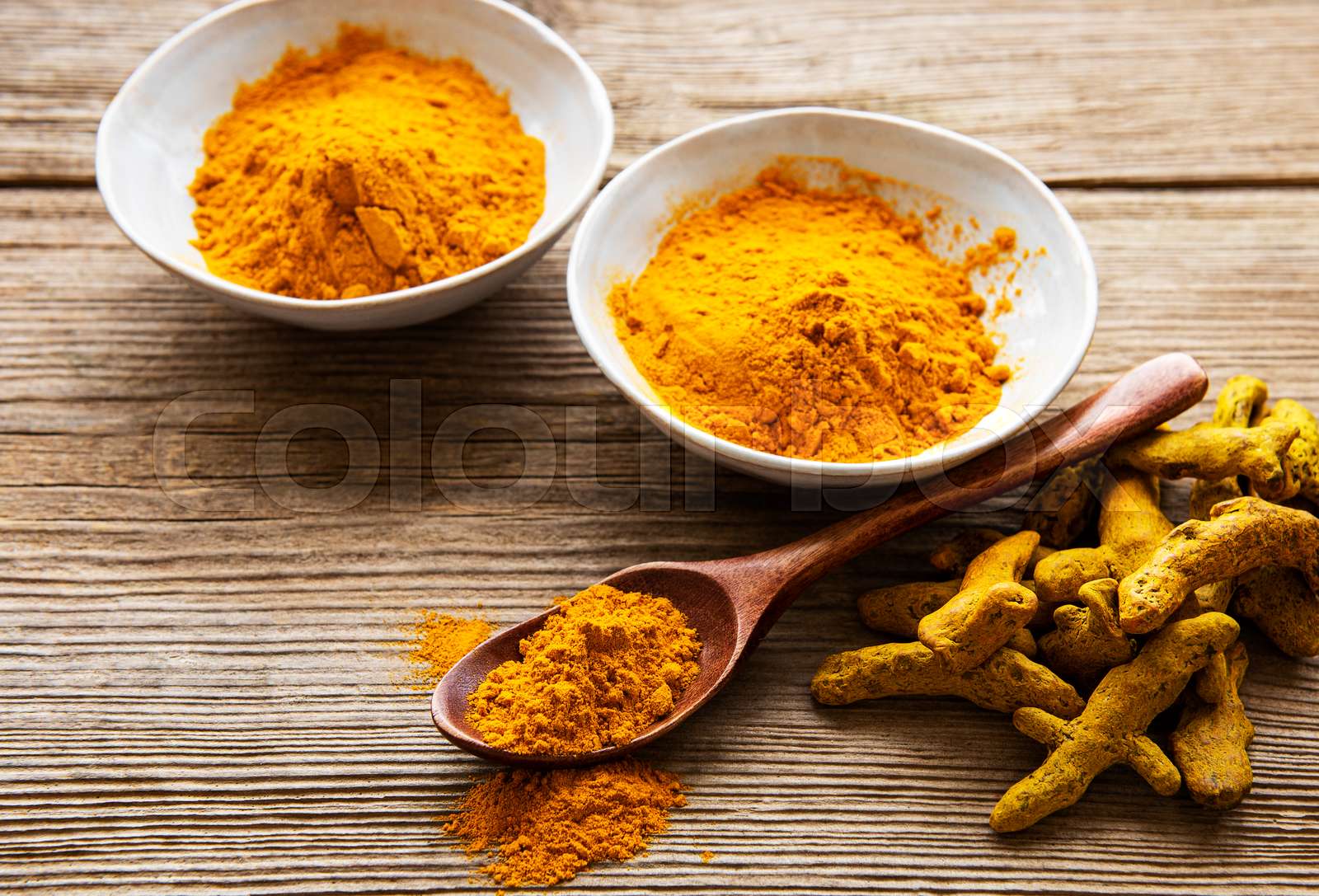 Yellow turmeric powder and dry roots | Stock image | Colourbox