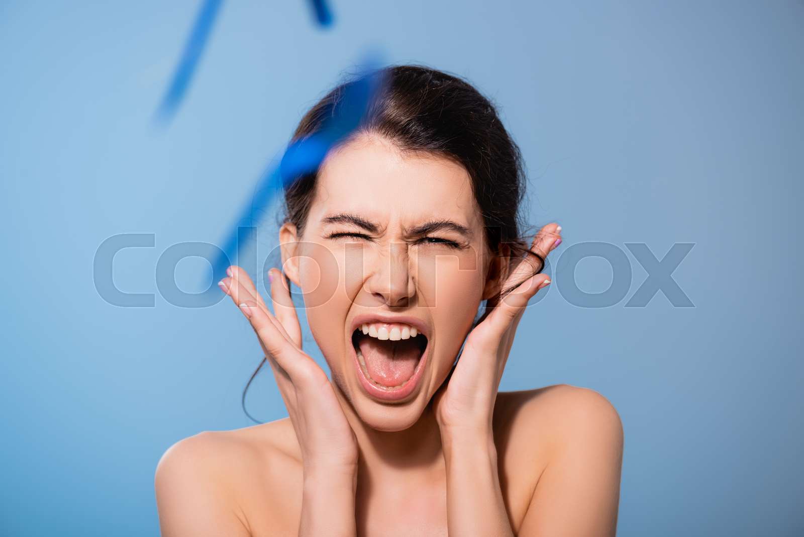 selective focus of naked woman screaming near falling plastic forks on ...