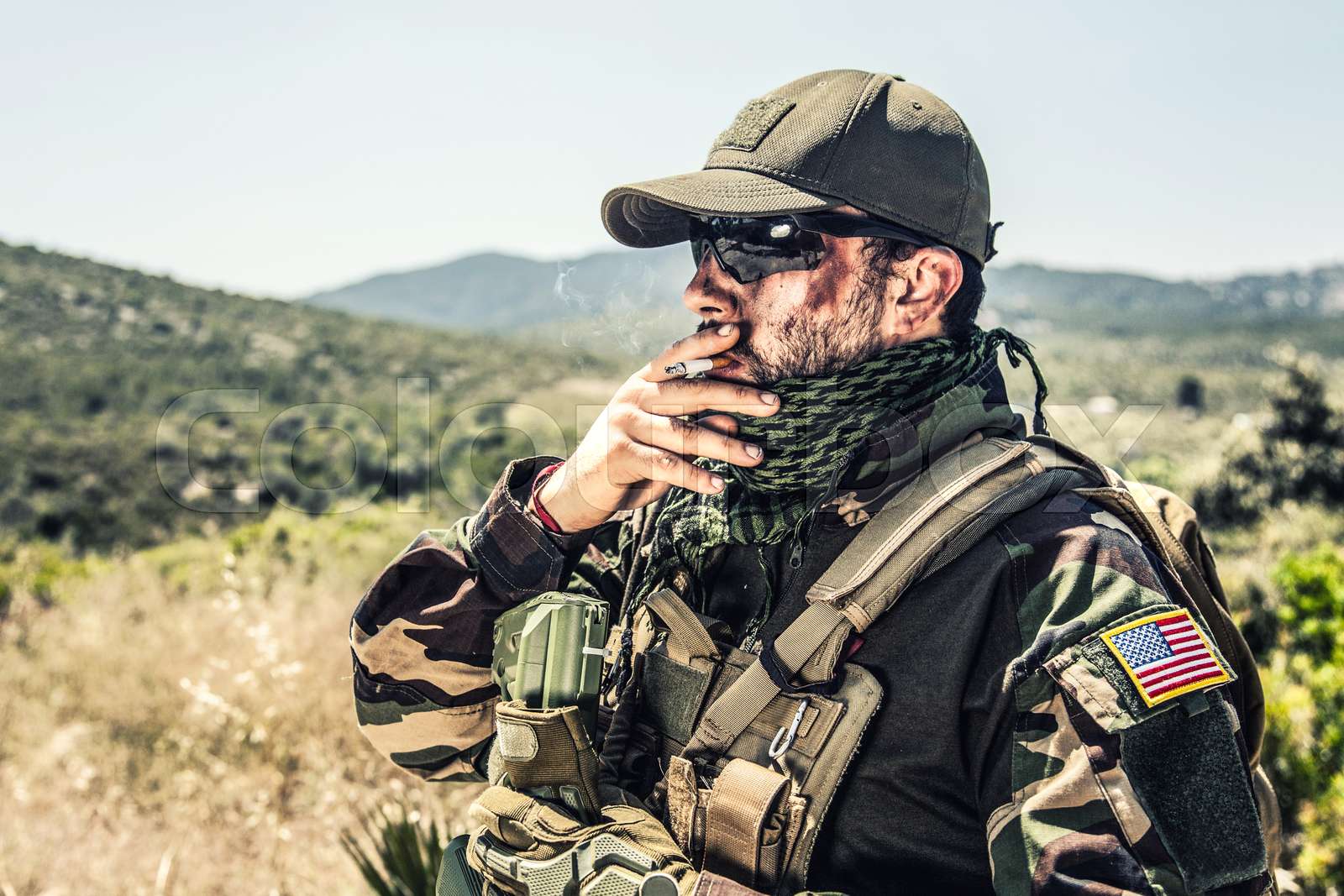 Army special forces soldier smoking cigarette | Stock image | Colourbox