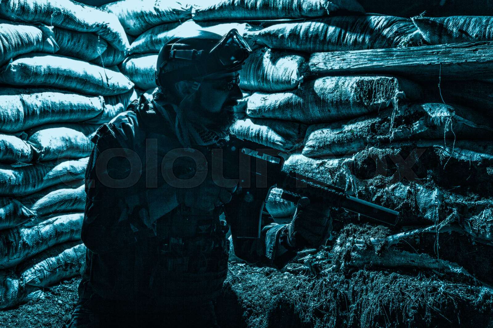 Navy SEALs fighter in night watch in trench | Stock image | Colourbox