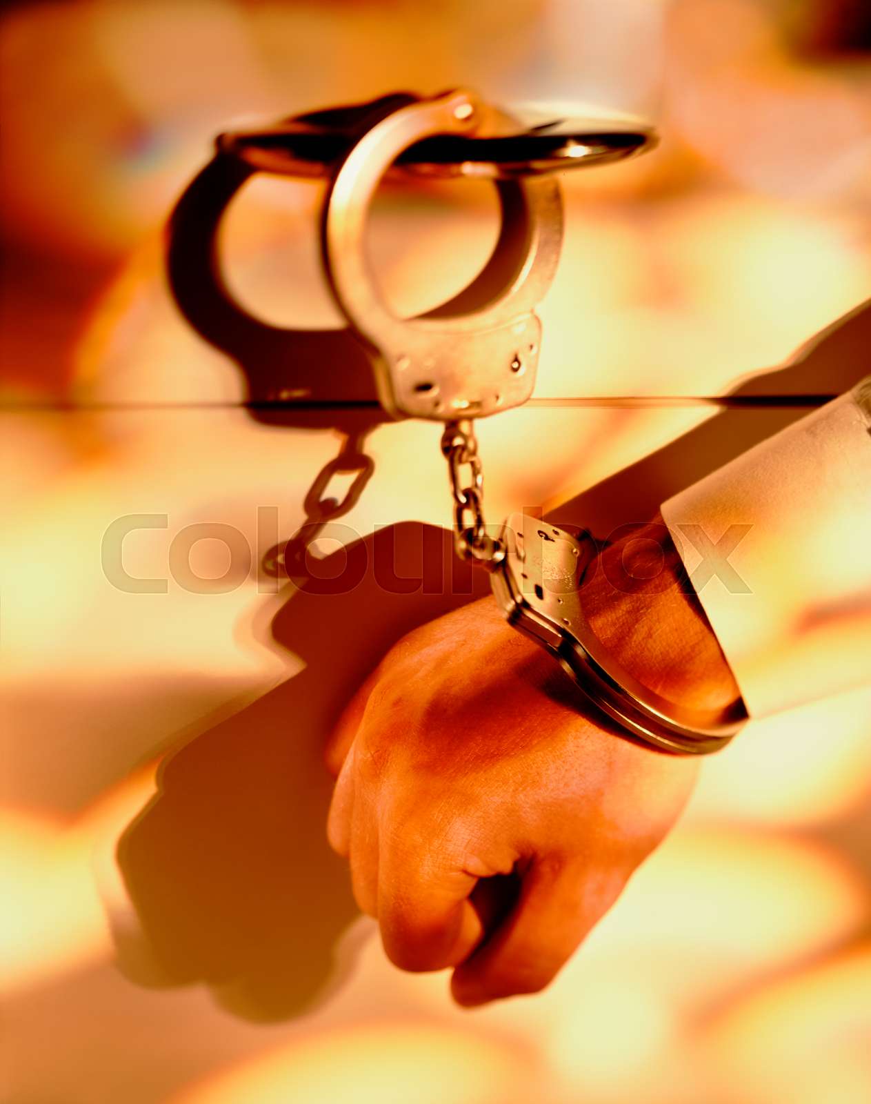 Business person handcuffed to desk with Dramatic Lighting. | Stock ...